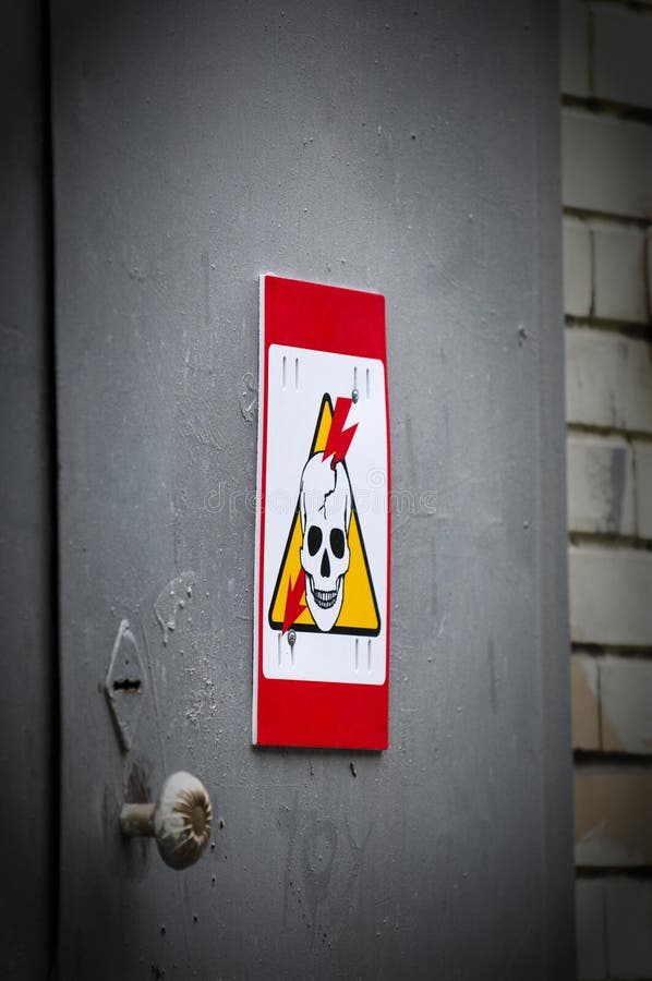High Voltage Danger Yellow Sign on a Brick Wall Building. Stock Image ...