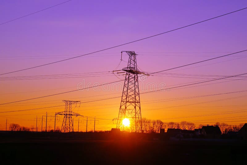 High Voltage Distribution Power Lines Pylon at Sunset Stock Photo ...