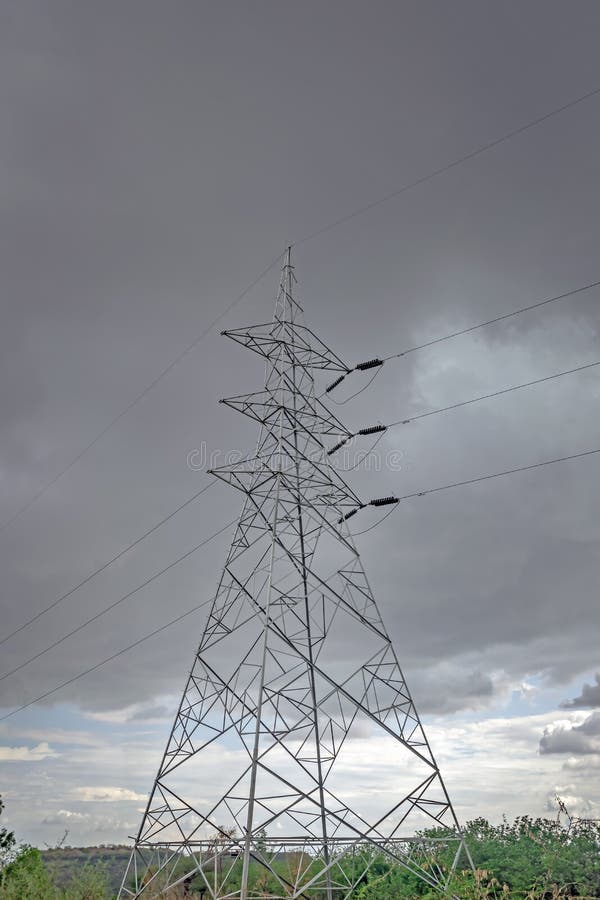 High Voltage Electric Line Tower with Dark Monsoon Cloud Background ...