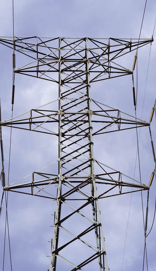 High Voltage Electrical Tower, Blue Sky in the Background Stock Photo ...