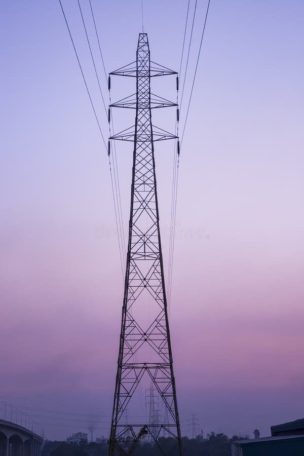 High Voltage Electricity Pylon Under the Cloudy Blue Sky Stock Photo ...