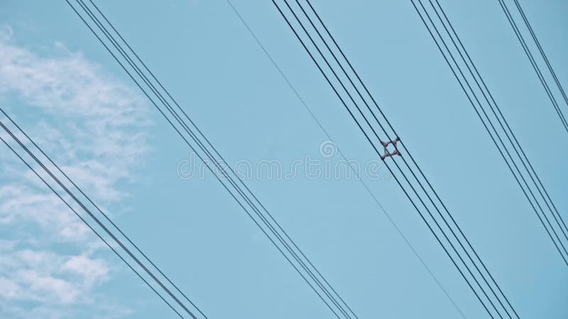 High Voltage Electricity Wires High in the Blue Sky Stock Footage ...