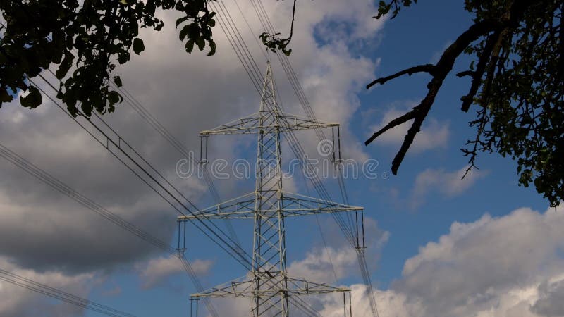 High Voltage Power Lines and Tall Towers Standing Strong Under a Clear ...