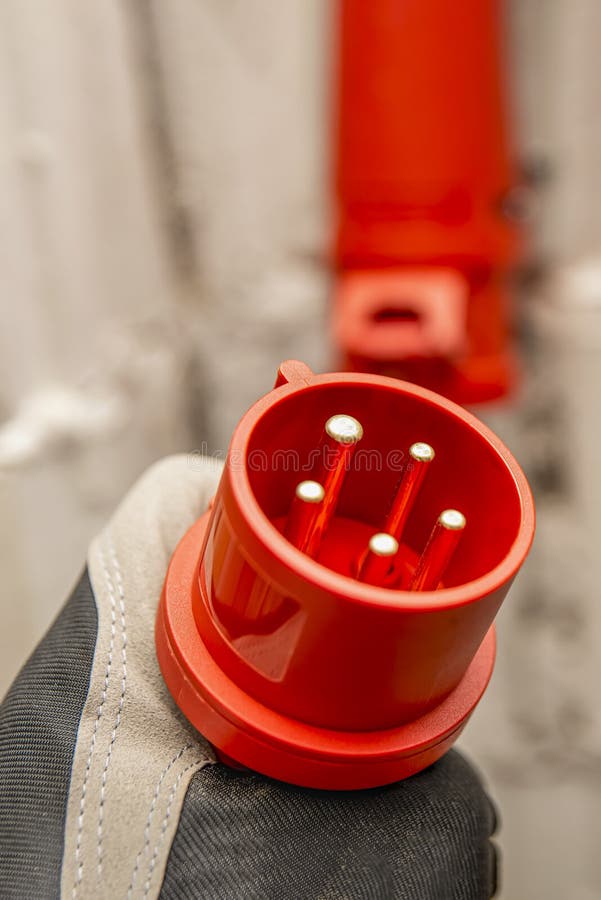 High Voltage Plug in Hand. Connecting a 380 Volt High Voltage, Three ...