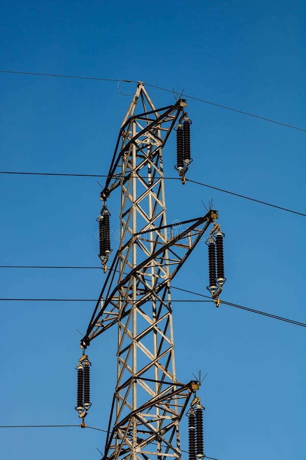 High Voltage Post. High Voltage Tower on Blue, Clear Sky Stock Photo ...