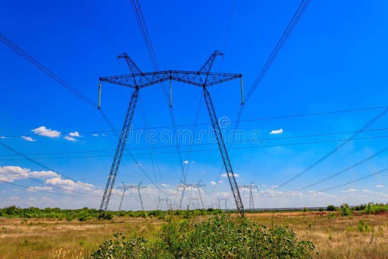 High Voltage Power Line Against Blue Sky Stock Photo - Image of ...