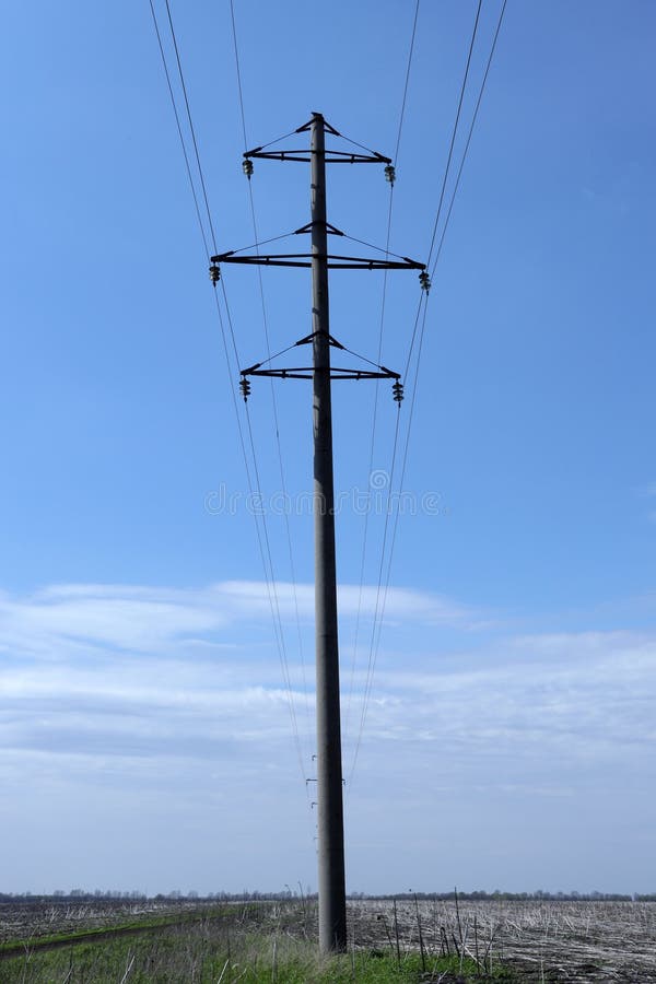 High Voltage Power Line Against the Blue Sky. Vertical Orientation ...