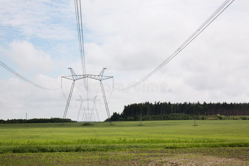 High Voltage Power Line in a Field Stock Image - Image of industrial ...