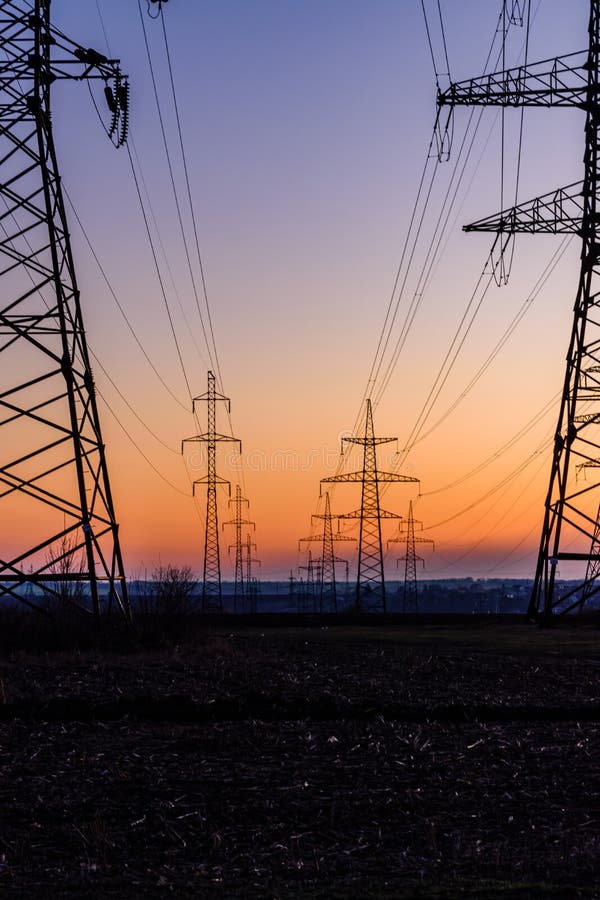 High Voltage Power Line in a Field at Sunset Stock Image - Image of ...