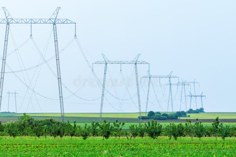 High-Voltage Power Line, Green Fields, Small Hills Countryside Stock ...