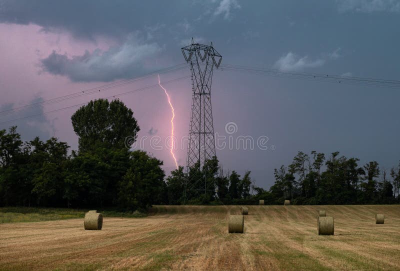 High Voltage Power Line with Lightning and Thunderstorm on the Evening ...