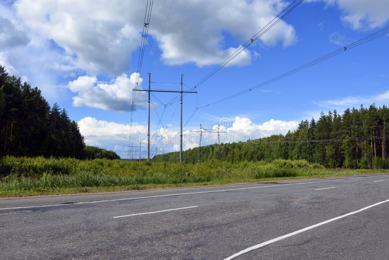 A High-voltage Power Line Runs through the Track. Electric Pole ...