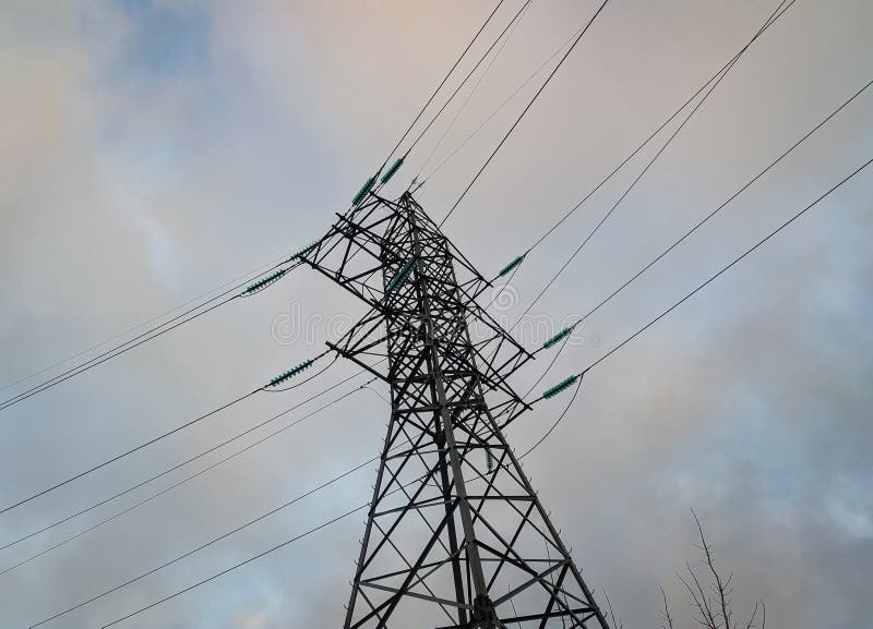 High-voltage Power Line Tower Against a Cloudy Sky Stock Photo - Image ...