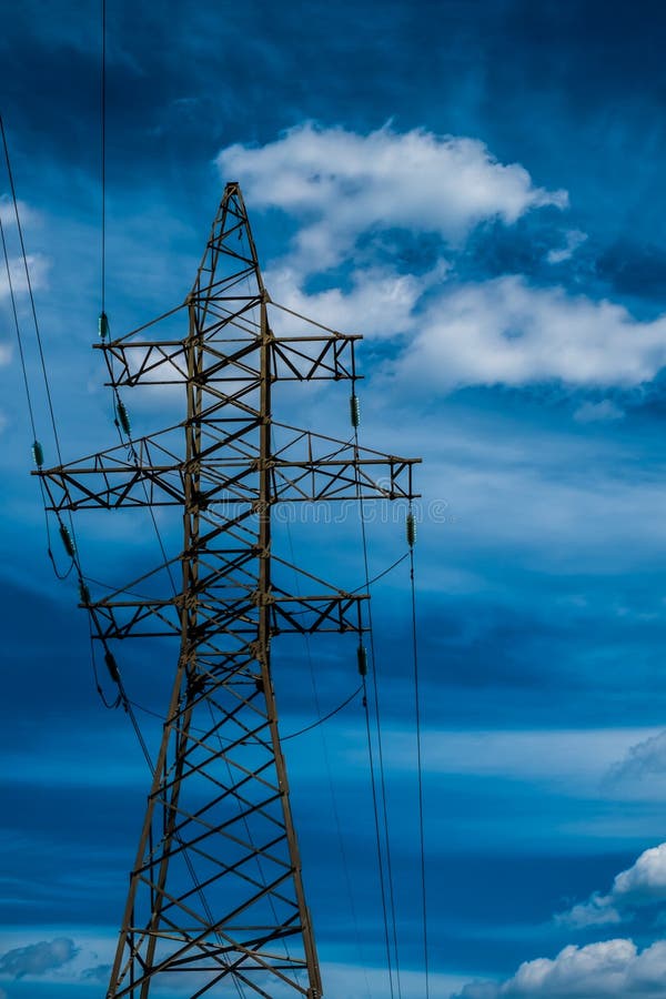 High Voltage Power Line Tower with a Blue Sky on Backgound Stock Photo ...