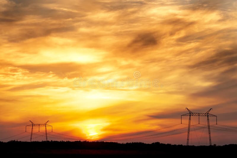High Voltage Power Lines Against a Dramatic Red Sunset Stock Photo ...