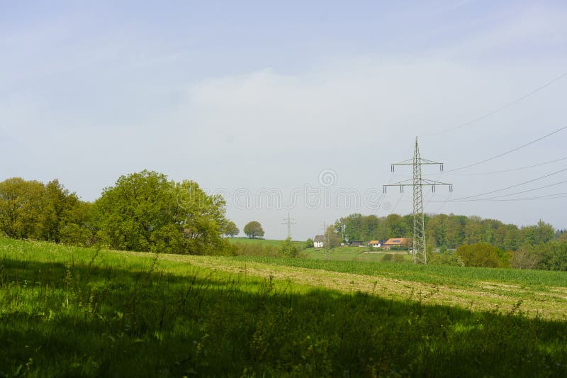 High-voltage Power Lines in a Green Meadow in German Spring Stock Photo ...