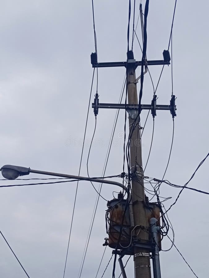High Voltage Power Lines on a Pole with Gray Sky Stock Image - Image of ...
