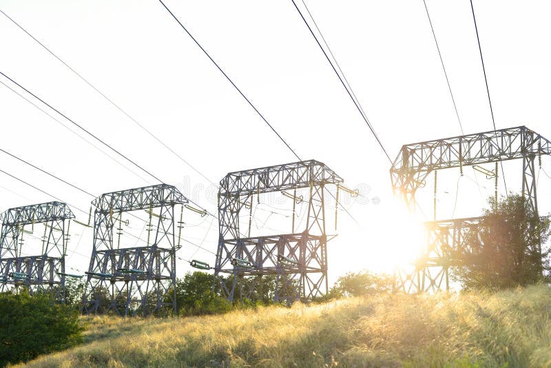 High-voltage Power Lines at Sunset. High Voltage Electric Transmission ...