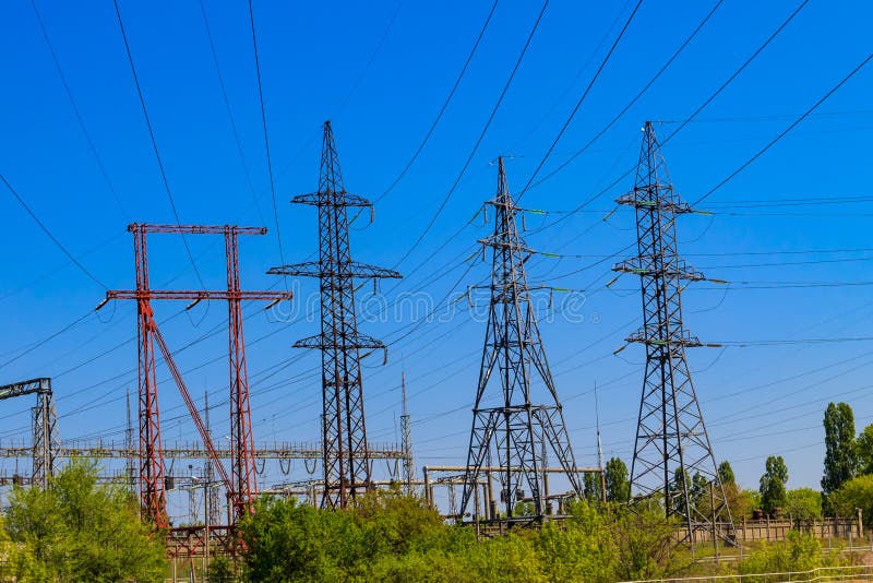 High Voltage Power Lines Towers on Blue Sky Background Stock Photo ...
