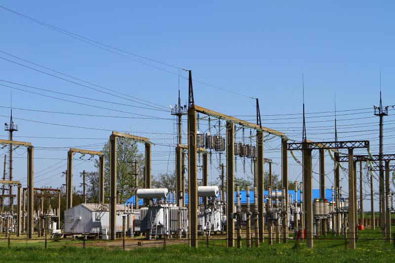 High-voltage Power Lines and Voltage Transformer Blocks on a Blue Sky ...