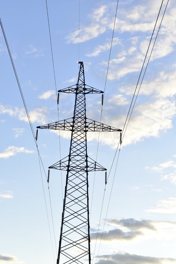 High-voltage Power Lines are Very High in the Forest Against the Sky ...