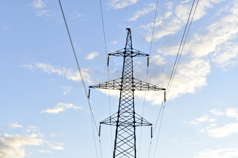 High-voltage Power Lines are Very High in the Forest Against the Sky ...