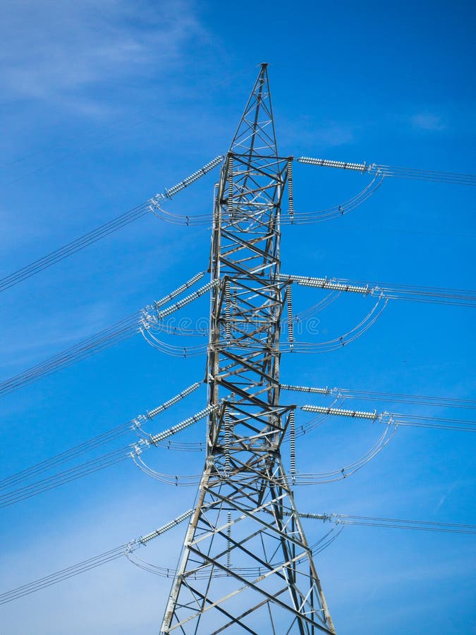 A High Voltage Power Pylons Against Blue Sky Stock Photo - Image of ...