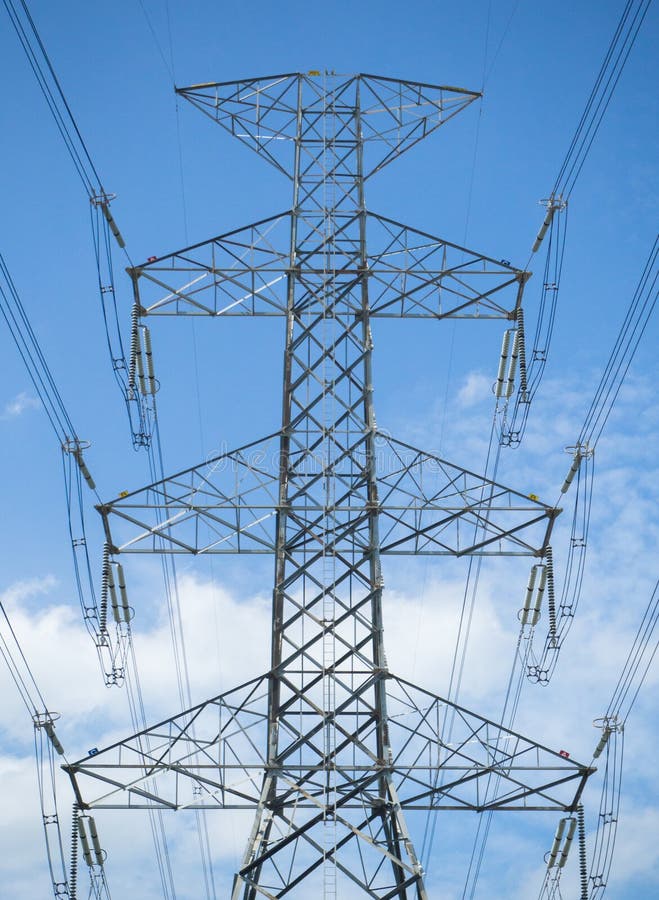 A High Voltage Power Pylons Against Blue Sky Stock Photo - Image of ...