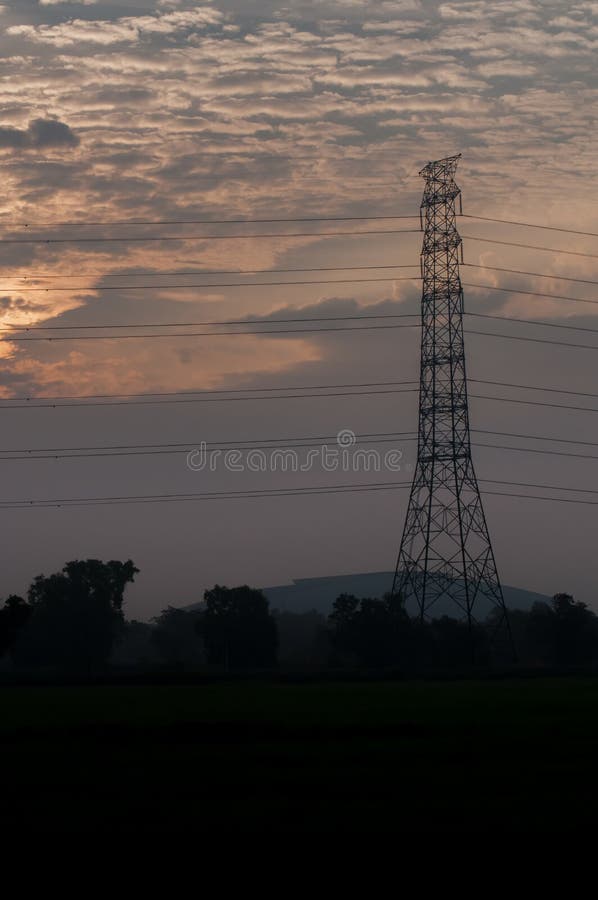 High Voltage Power Transmission Towers in Sunset Sky Background Stock ...