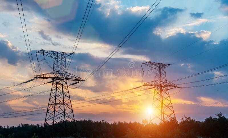 High-voltage Power Transmission Towers in Sunset Sky Background. Stock ...