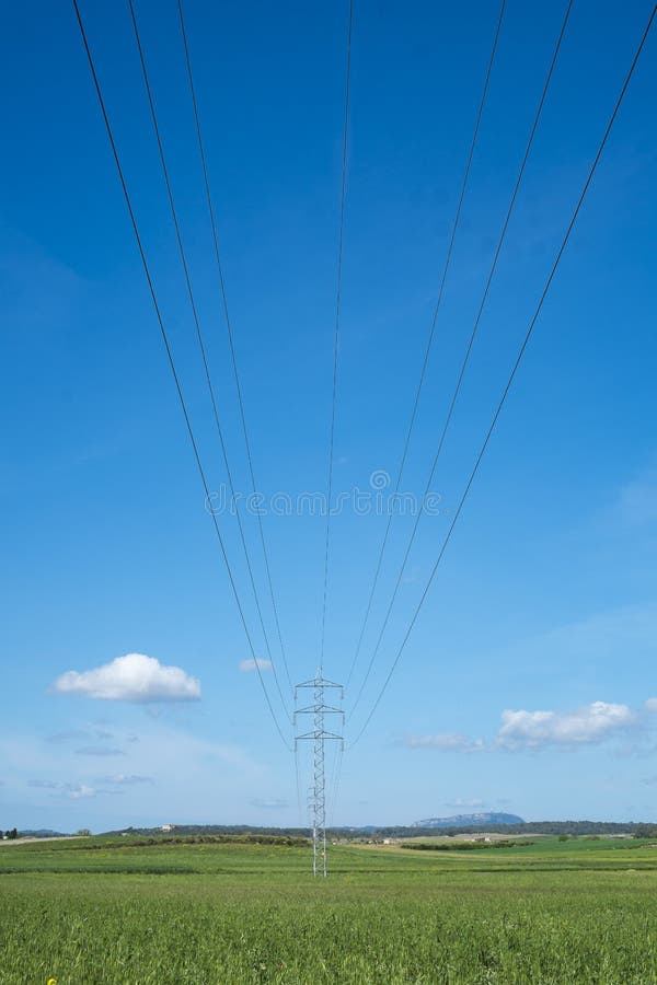 High Voltage Tower and Cable Line in the Countryside Under a Blue Sky ...