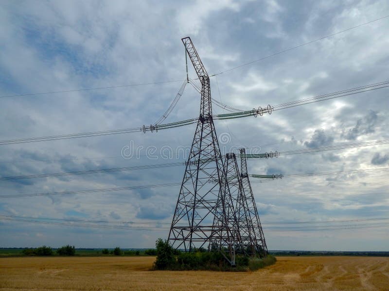 High Voltage Tower Standing in a Field with Wires Stock Photo - Image ...
