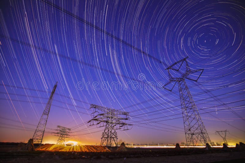 High-voltage Towers and Stellar Trajectories Stock Photo - Image of ...