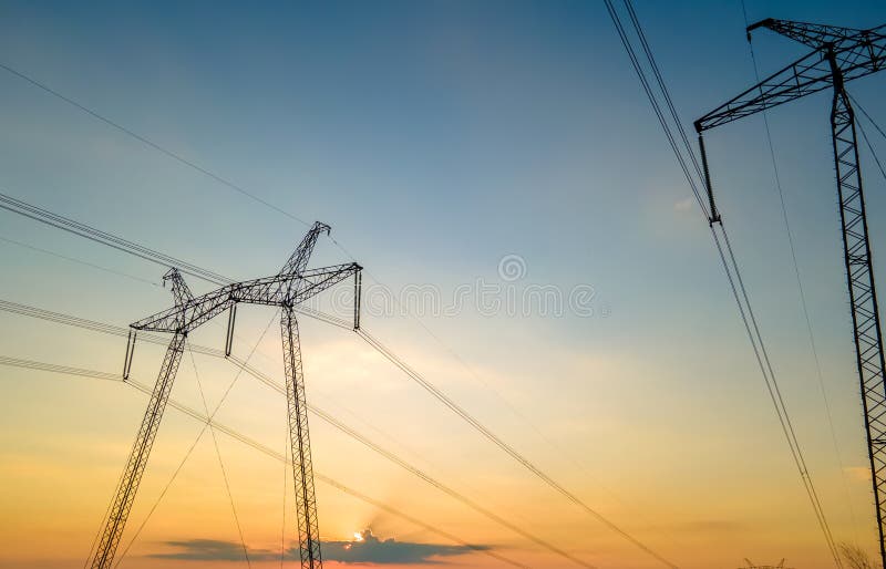 High Voltage Towers with Electric Power Lines at Sunset Stock Photo ...