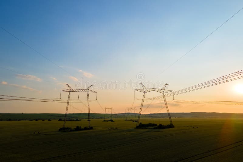 High Voltage Towers with Electric Power Lines at Sunset Stock Photo ...