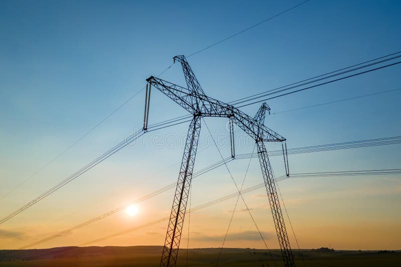 High Voltage Towers with Electric Power Lines at Sunset Stock Photo ...