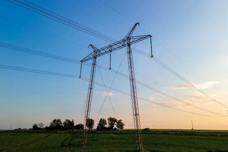 High Voltage Towers with Electric Power Lines at Sunset Stock Photo ...