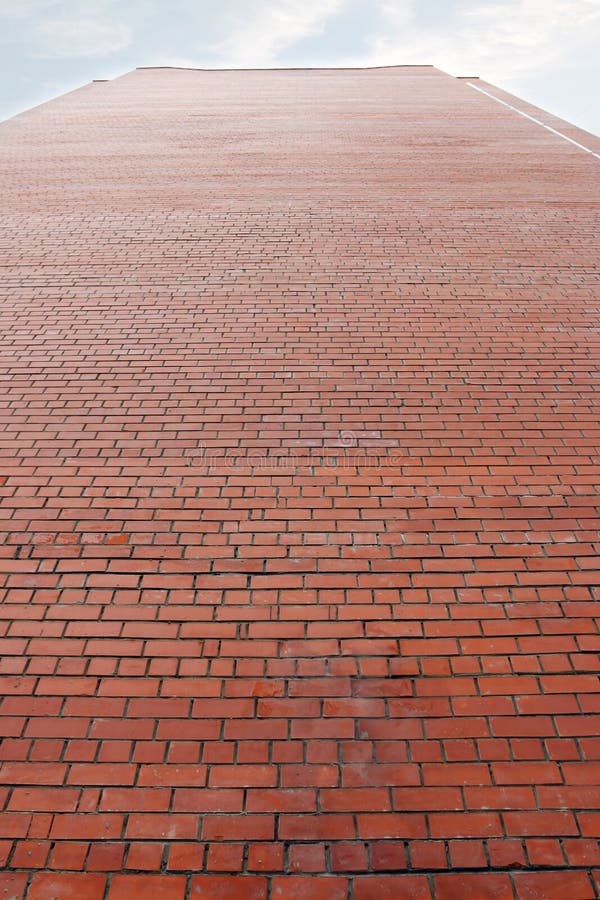 High Wall of Bright Red Brick Building and Cloudy Sky Stock Photo ...