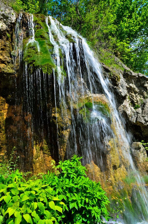 High Waterfall into the Forest Stock Image - Image of forest, rocks ...