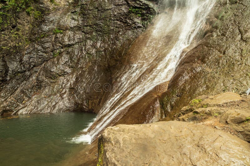 A High Waterfall in a Green Forest with Rocks Stock Image - Image of ...