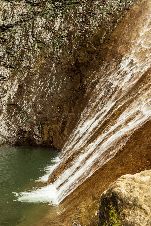 A High Waterfall in a Green Forest with Rocks Stock Image - Image of ...
