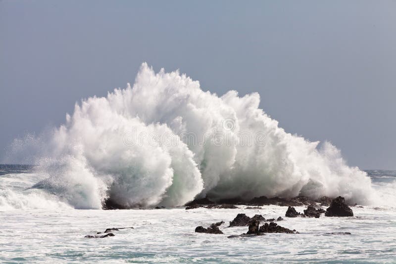 High Wave Breaking on the Rocks Stock Image - Image of blue, rocks ...