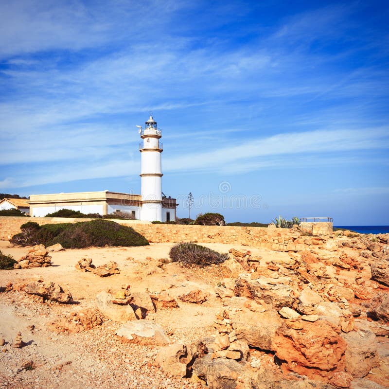 High White Lighthouse on a Rocky Sea Coast Stock Photo - Image of ...