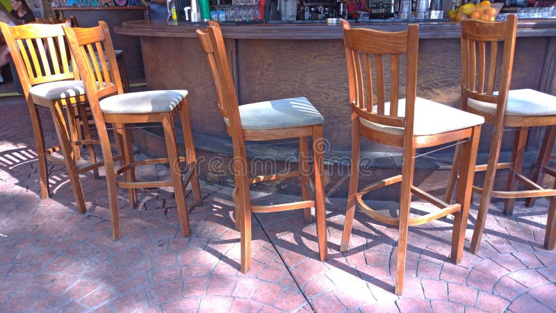 High Wooden Bar Stools and a Bar Counter in the Street Stock Image ...