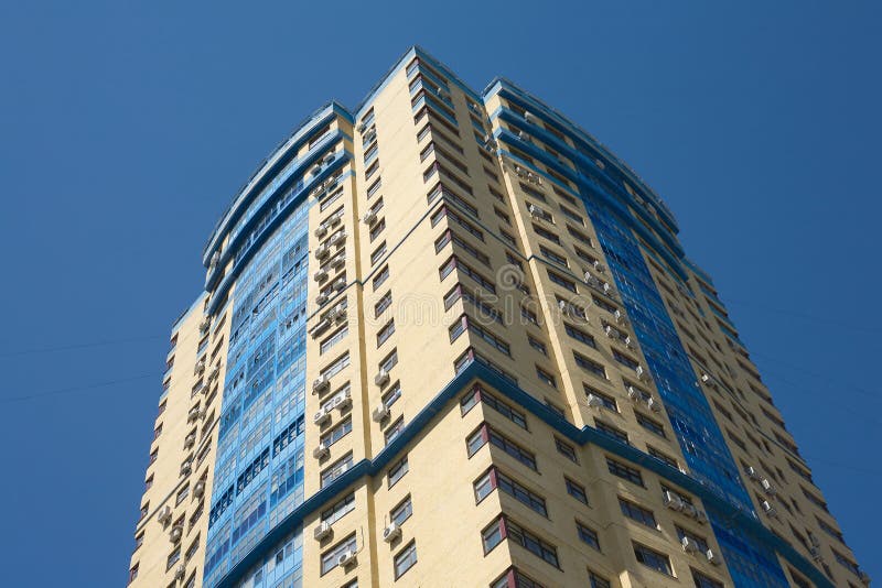 High Yellow Modern Building on Blue Cloudless Sky Vertical View Stock ...