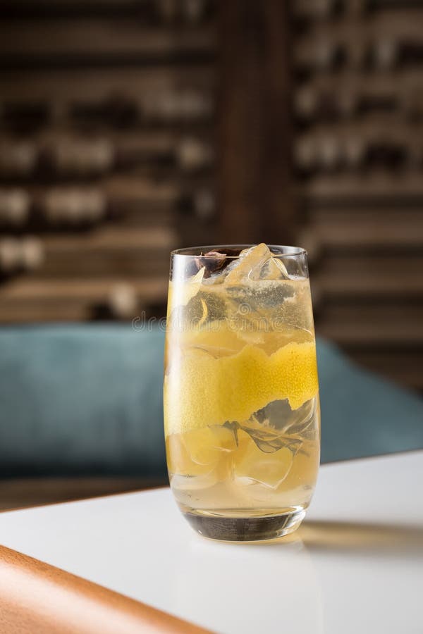 Highball Cocktail with Lemon Peel, Anise and Ice on the Table at ...