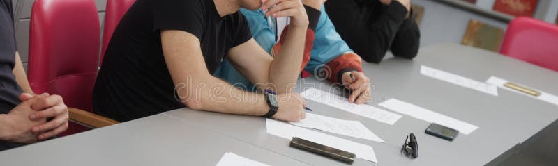 Higher Education Students Sitting Thoughtfully at a Desk during a ...