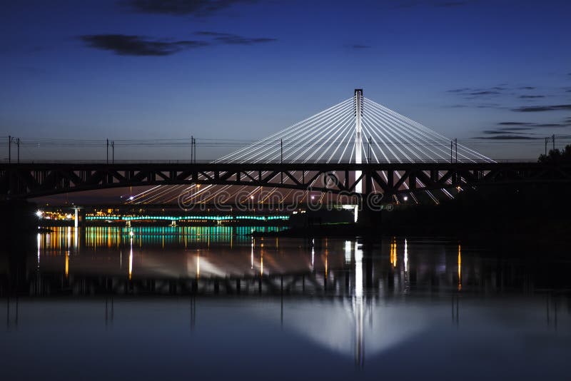 Highlighted Bridge at Night and Reflected in the Water Stock Photo ...