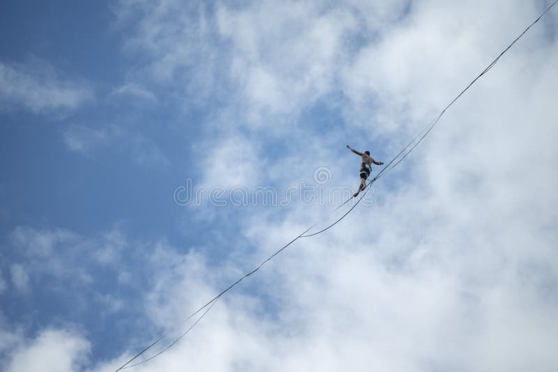 Highline Slackline Walking Over Valley with Walking Man with Clouds on ...