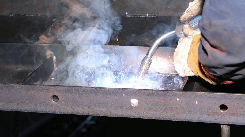 A Highly Skilled Welder Welds a Metal Structure at an Assembly Plant ...